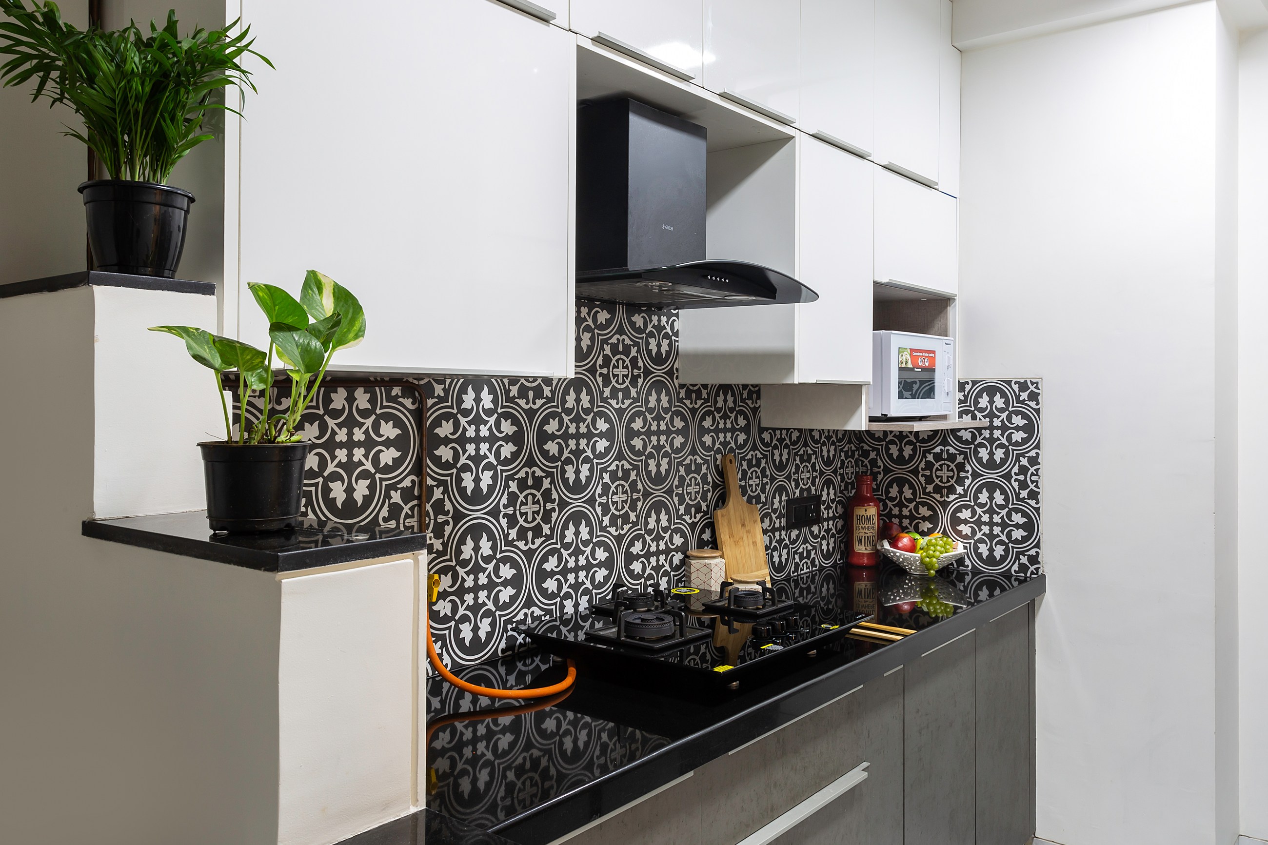Stain-Resistant Kitchen Tile Design In Contrasting Shades | Livspace