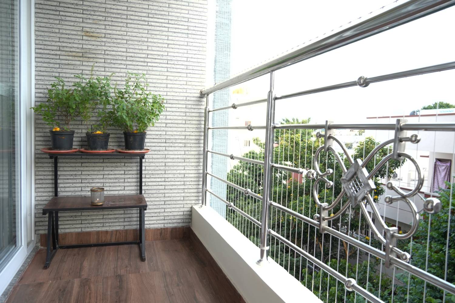 Modern Balcony Design With Stone Cladding And Green Herb Garden | Livspace