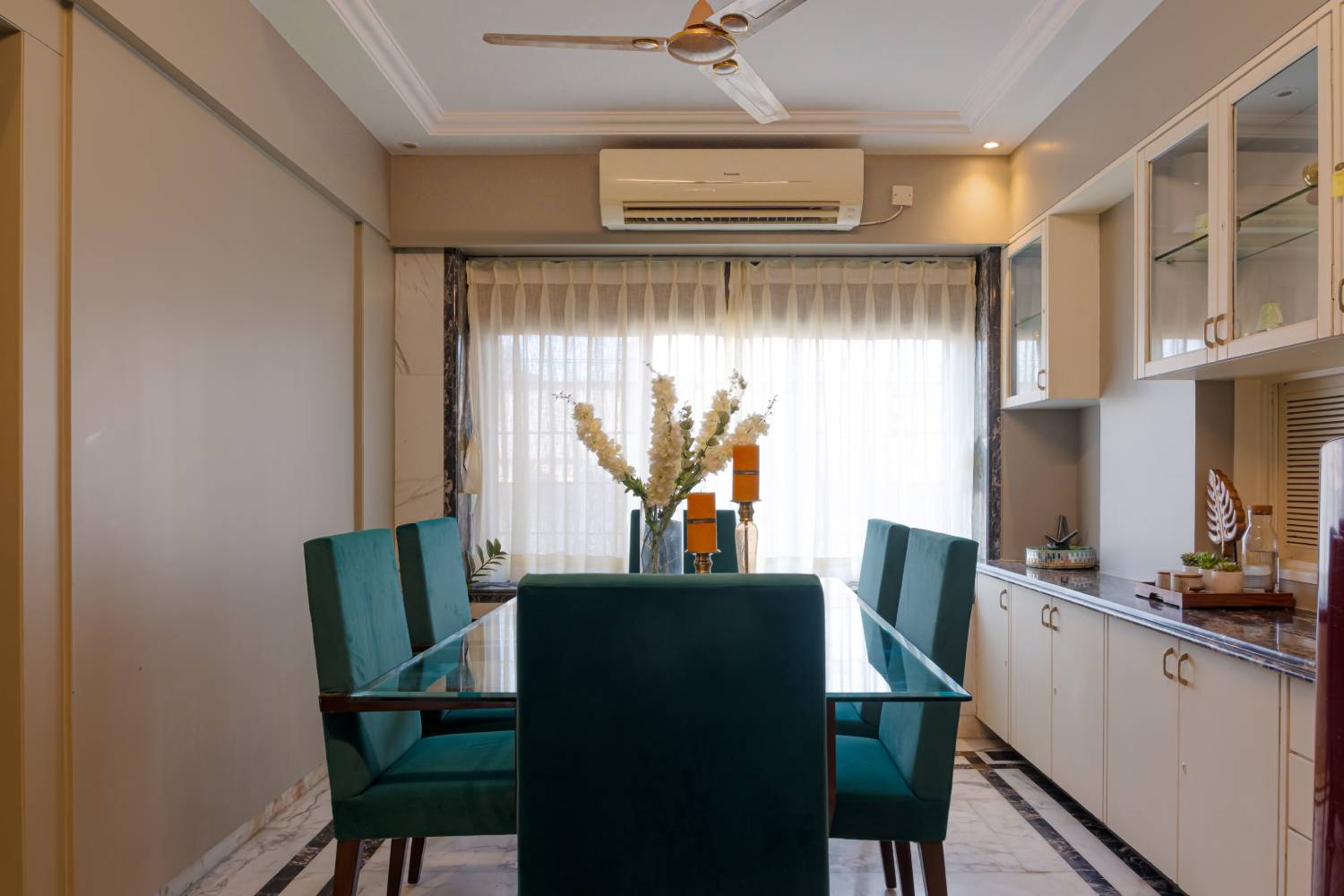 Modern Teal Velvet 6-Seater Dining Room Design with Glass Table | Livspace