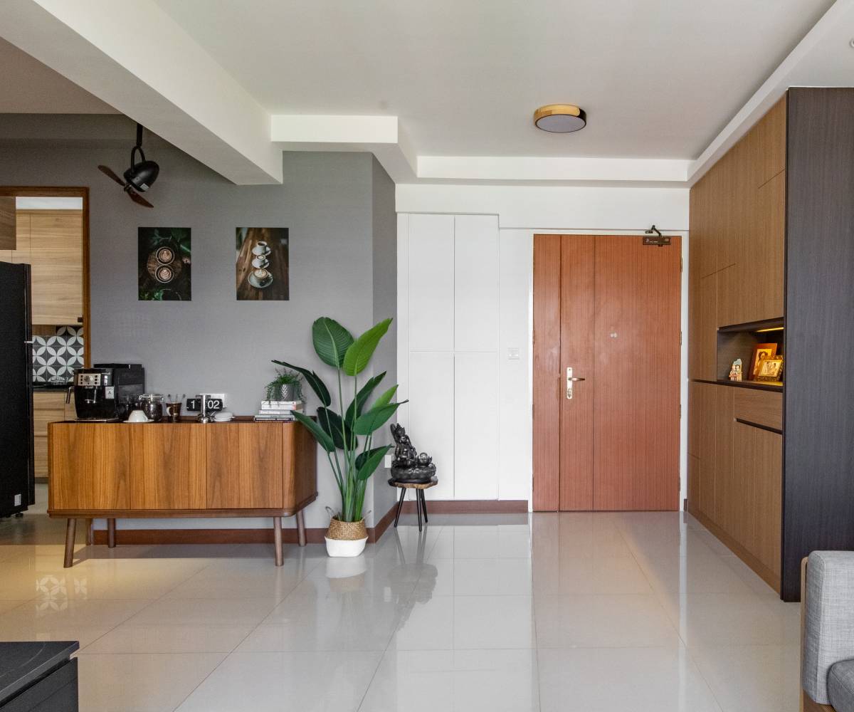 White And Brown Foyer Design With Floor-To-Ceiling Storage Unit | Livspace