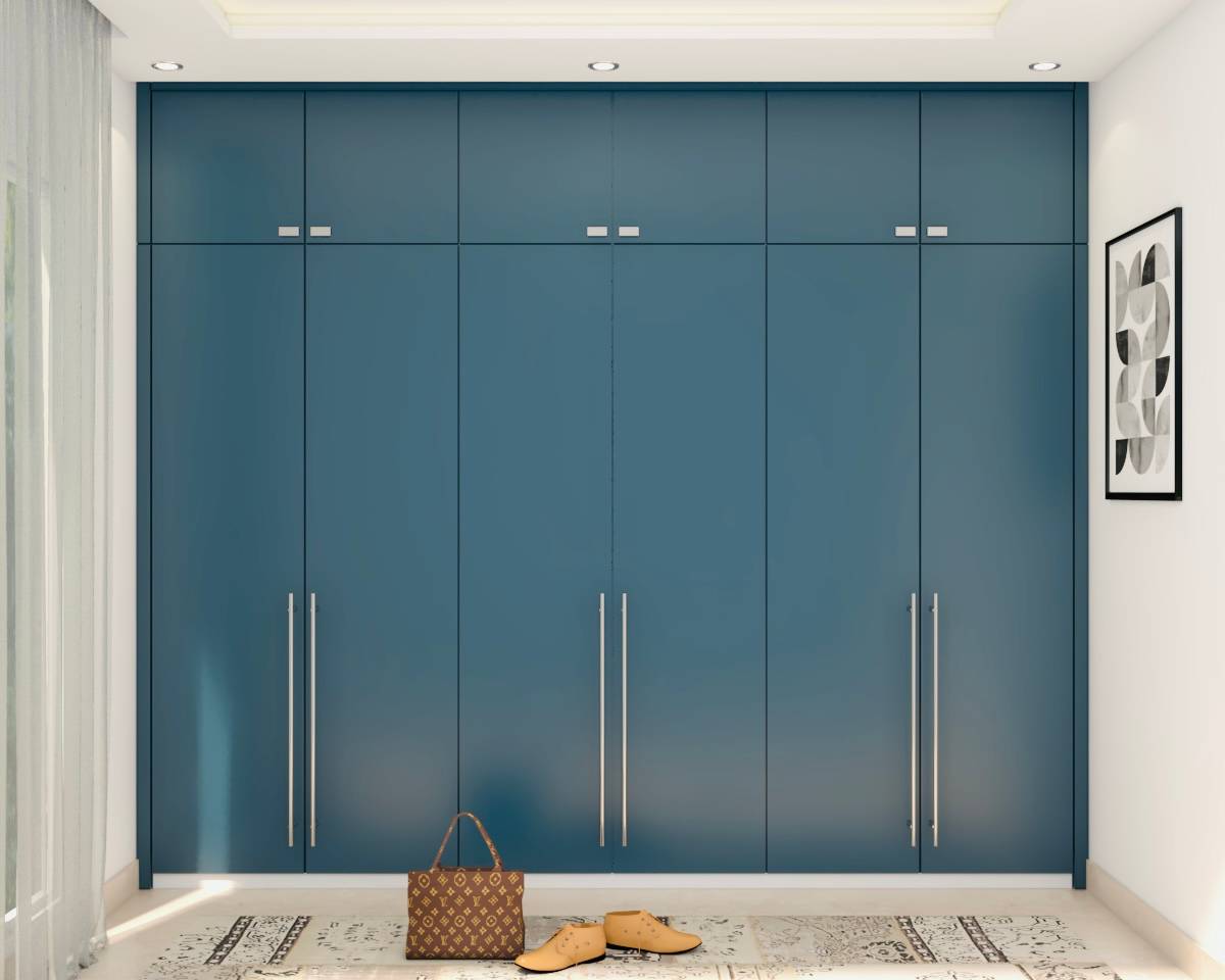 Modern Matt Blue Finished Wardrobe Design with Metallic Handles | Livspace