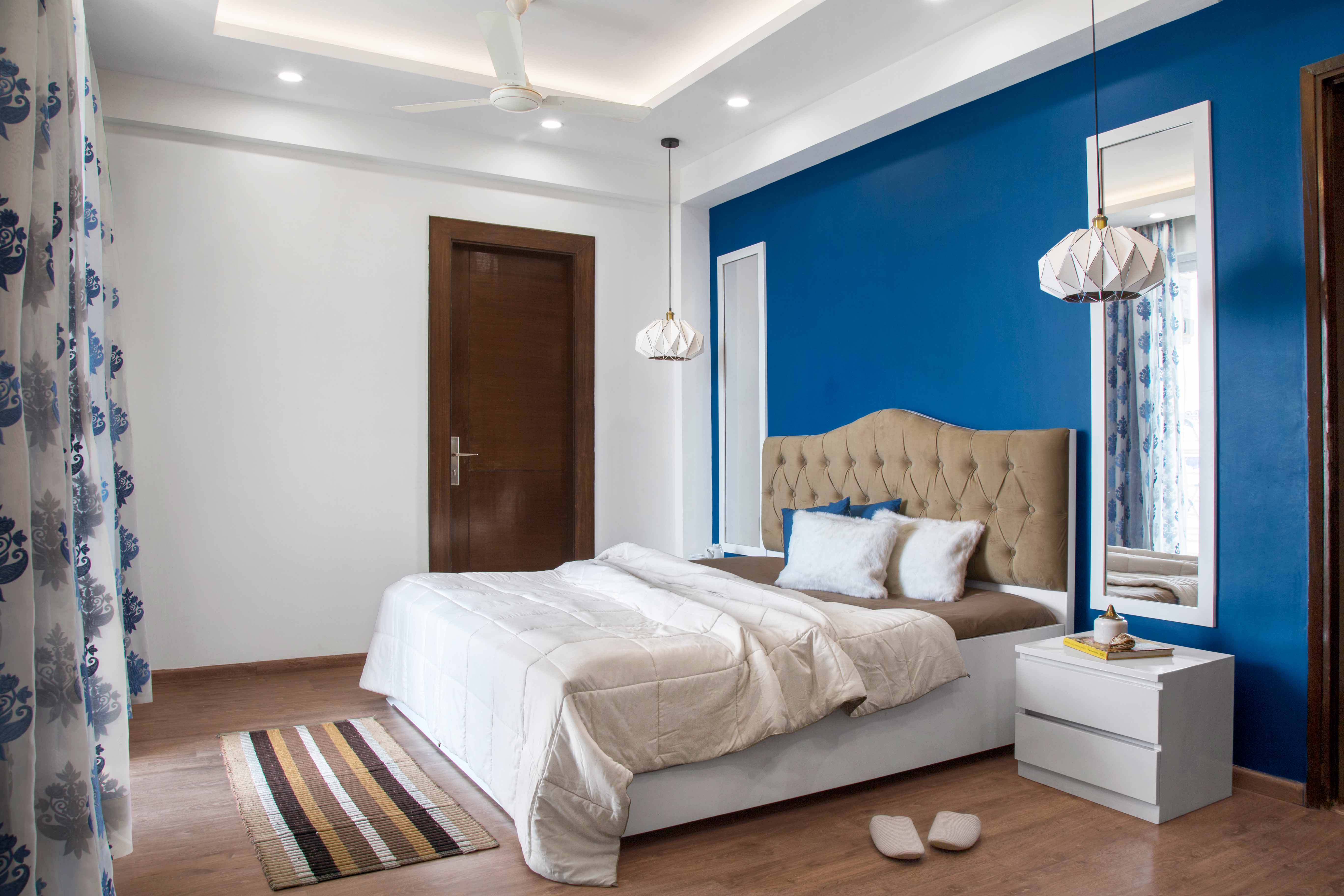 Guest Room Design With Blue Accent Wall - 12x9 Ft | Livspace