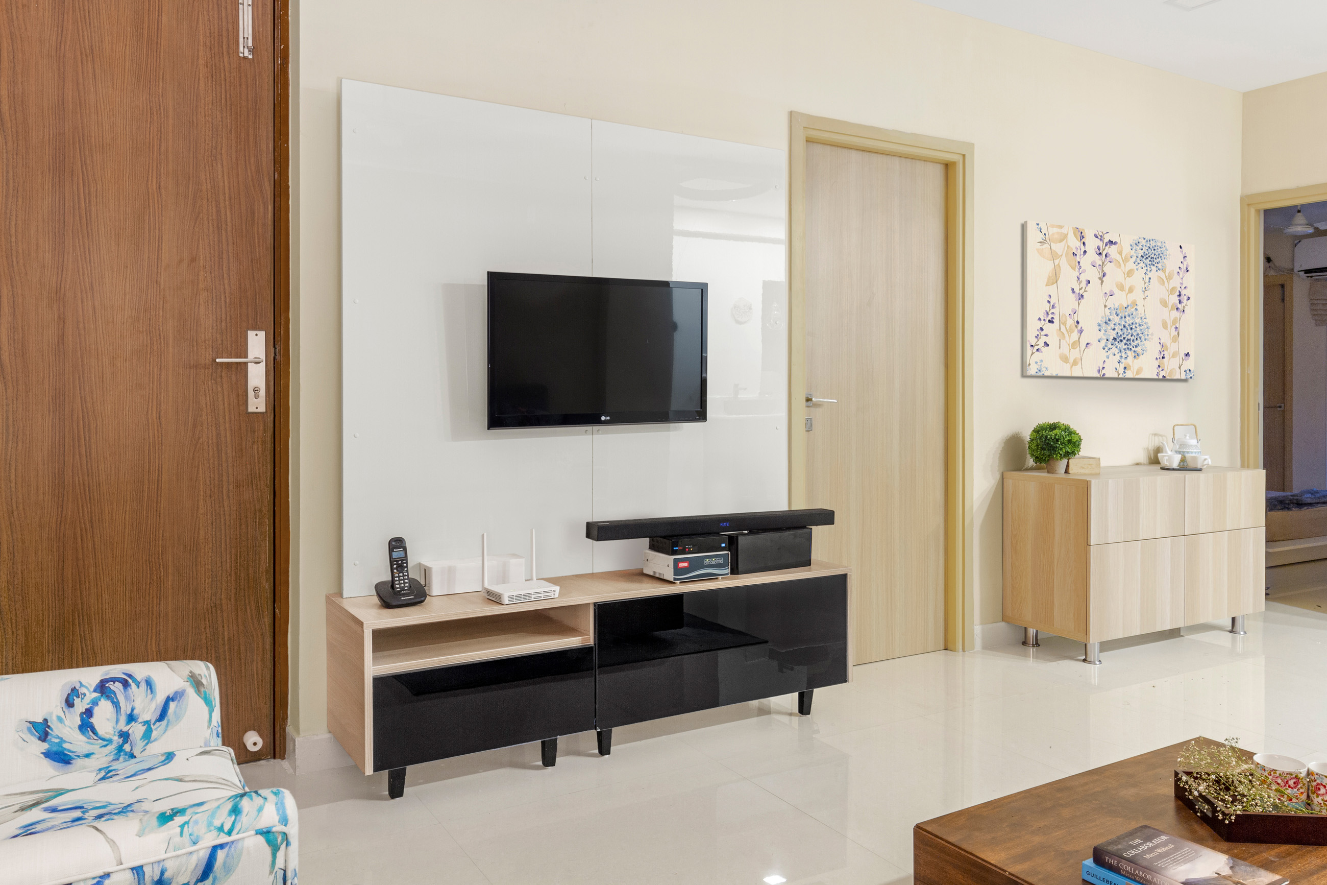 TV Unit Design With A Glossy Black Console | Livspace