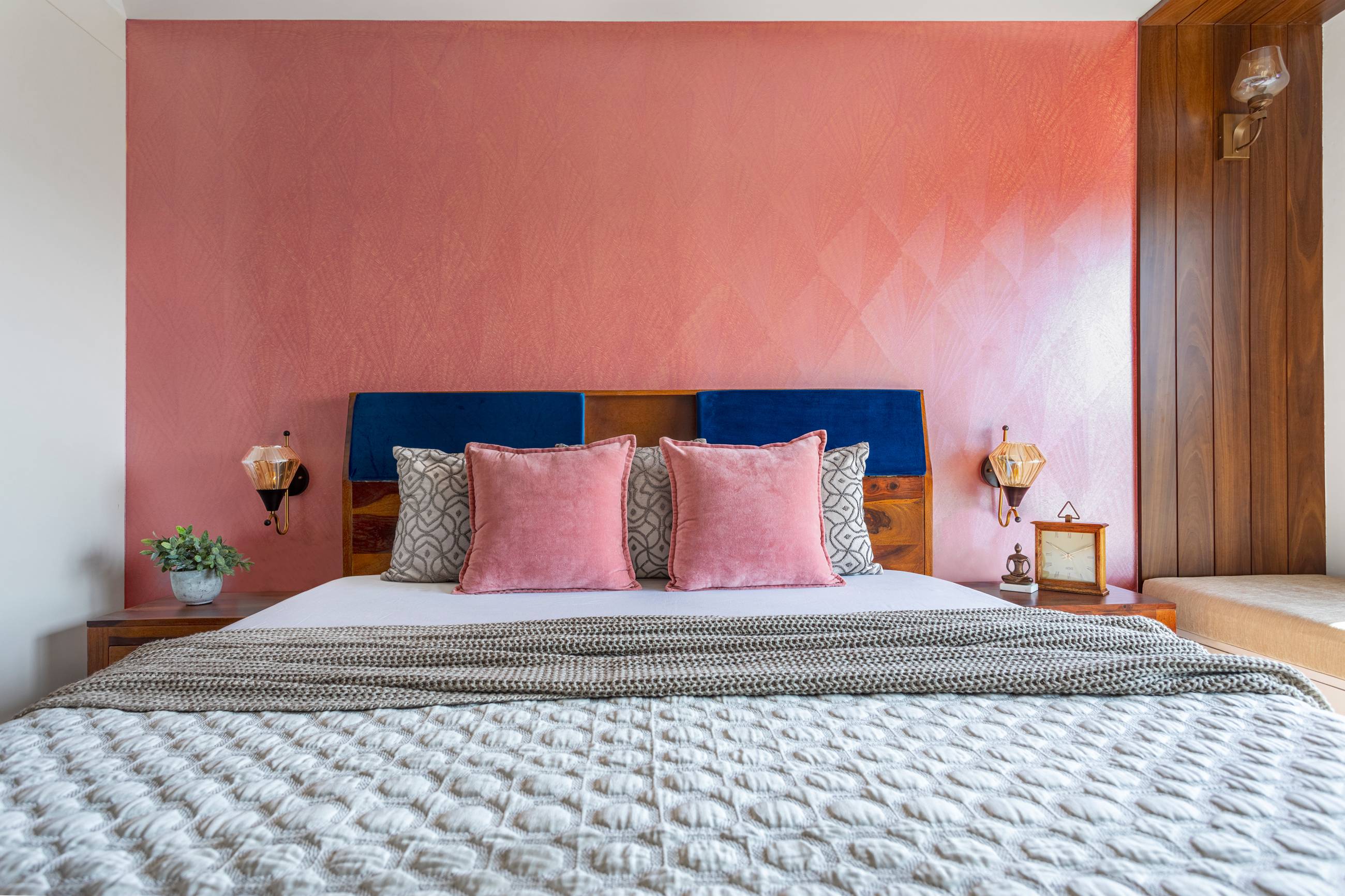 Spacious Bedroom Design With Peach Textured Walls | Livspace