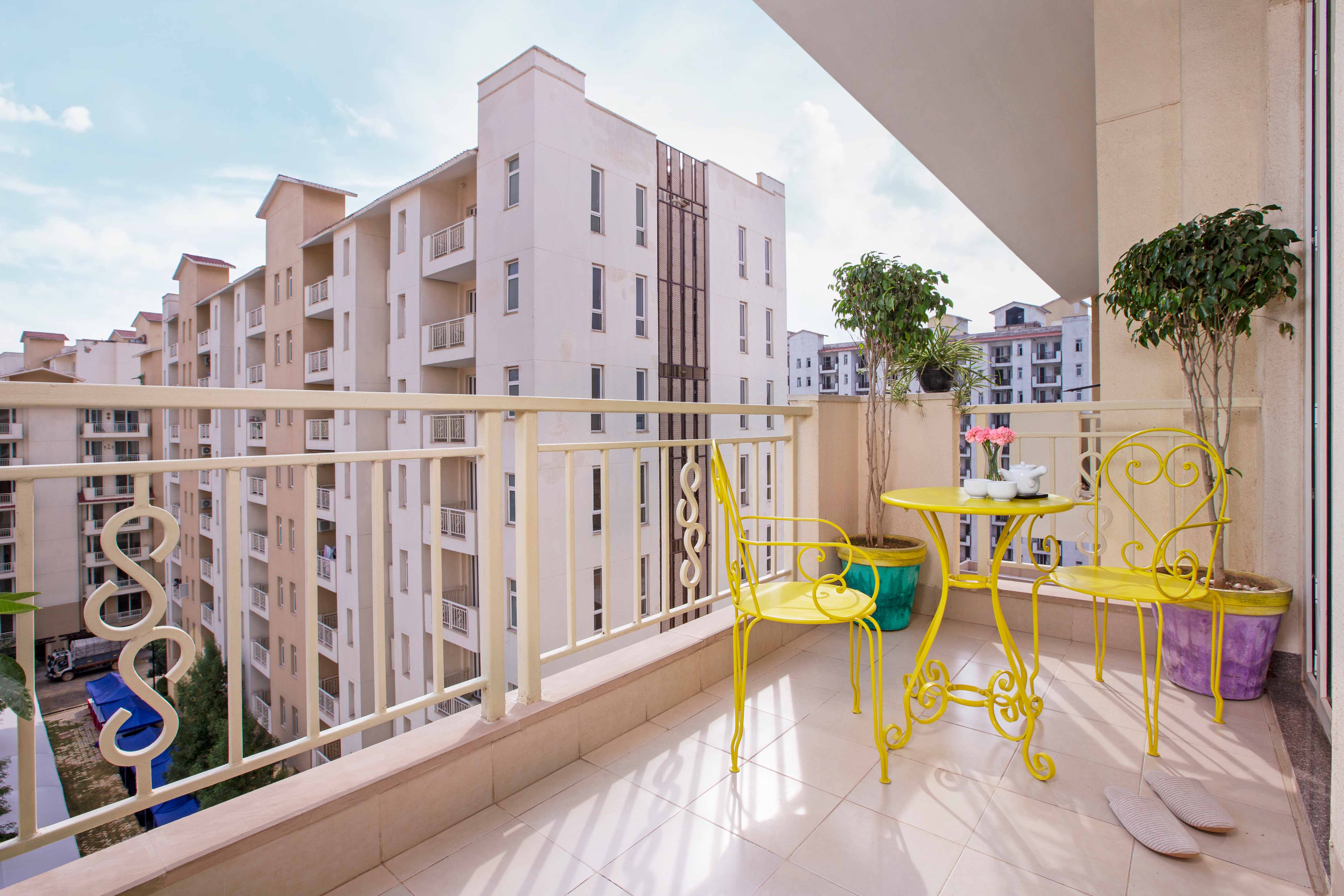 Balcony Design With Bright Yellow Metal Table | Livspace