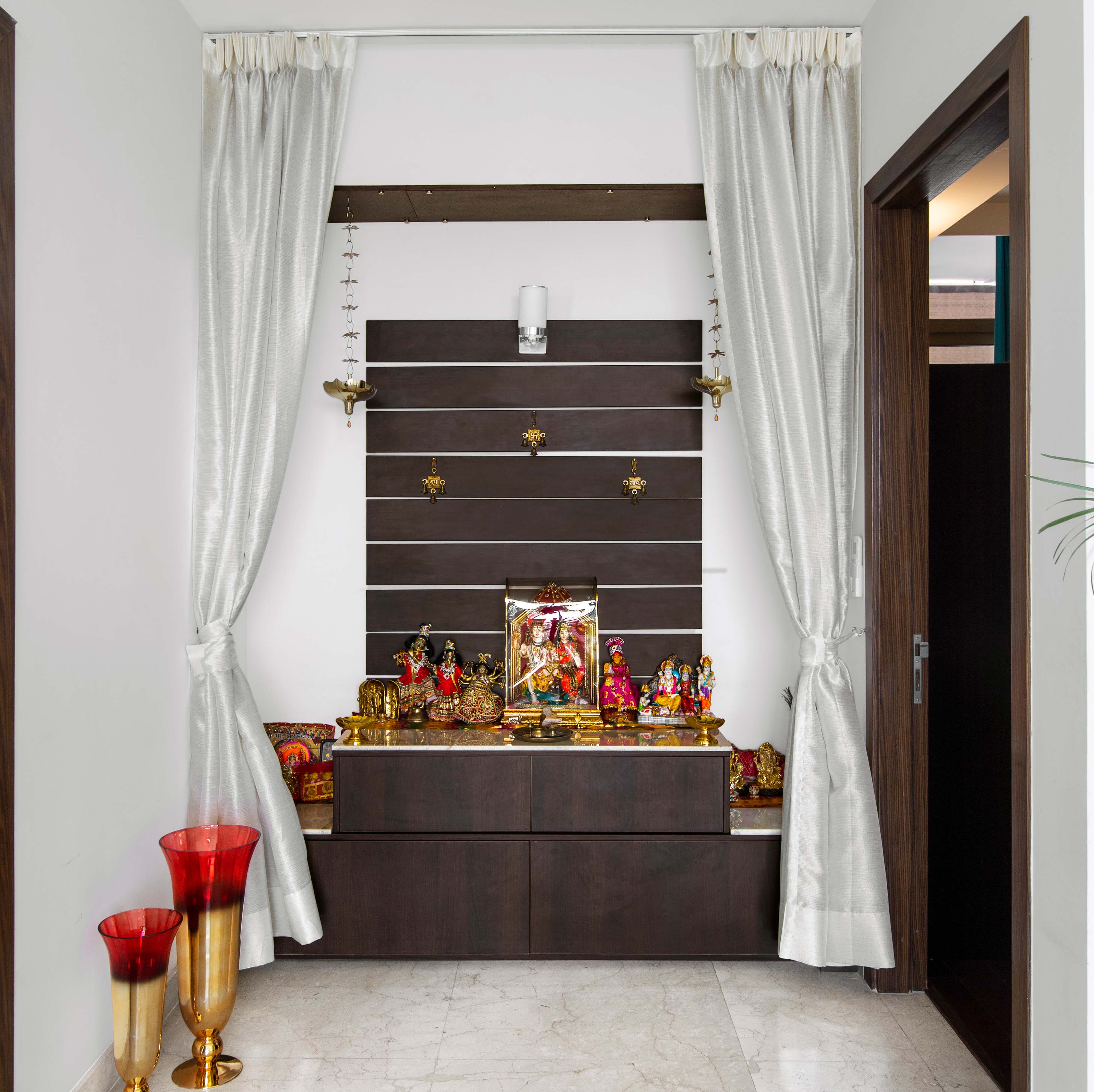 Mandir Design With Dark Wooden Panel And Floor-Mounted Unit | Livspace