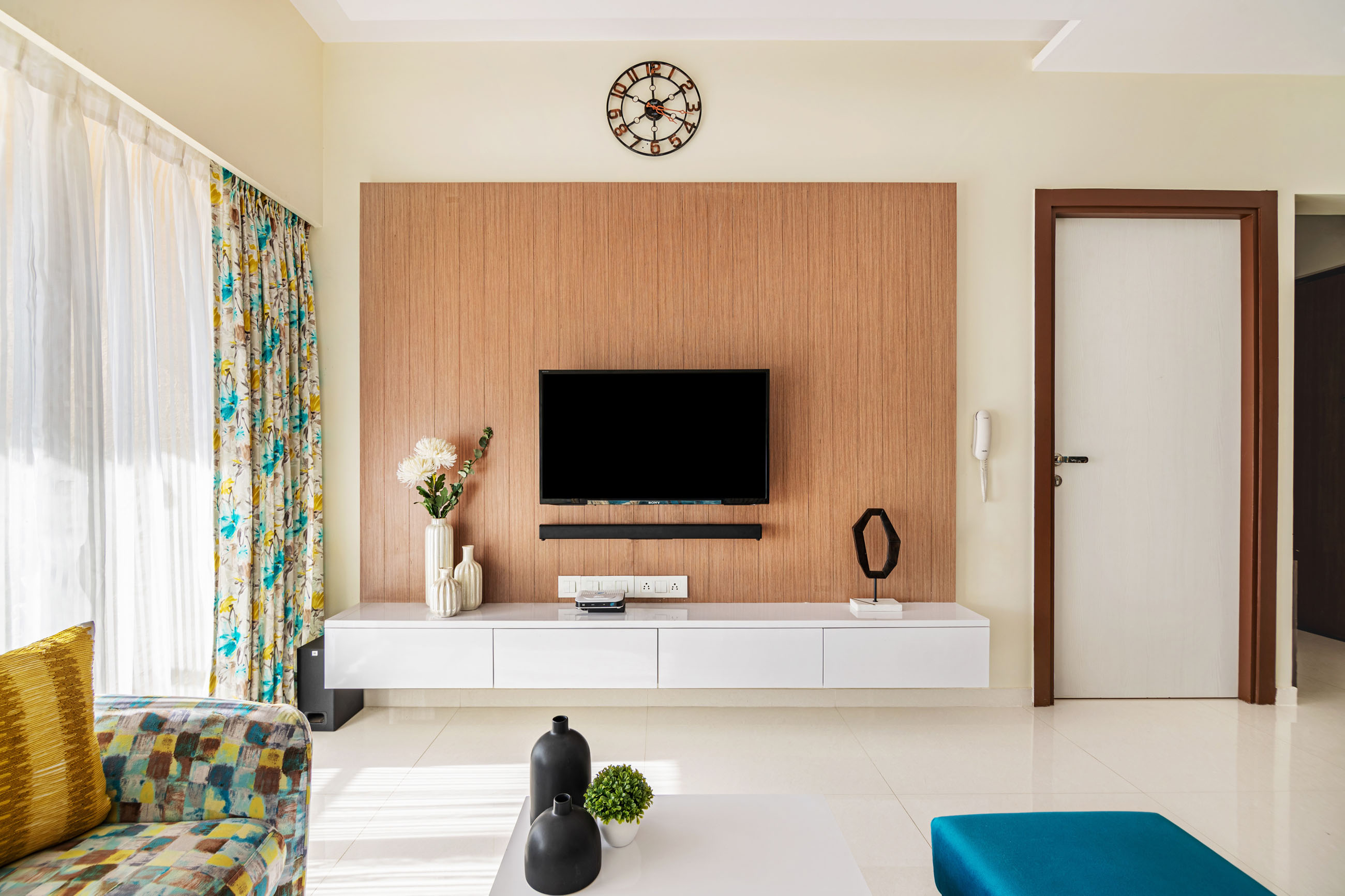 Wall-Mounted White TV Unit Design With Wooden Panelling | Livspace