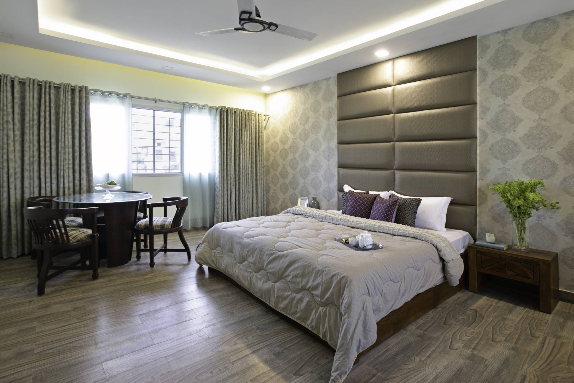 Spacious Guest Room Design With Floor-To-Ceiling Headboard And Floral ...